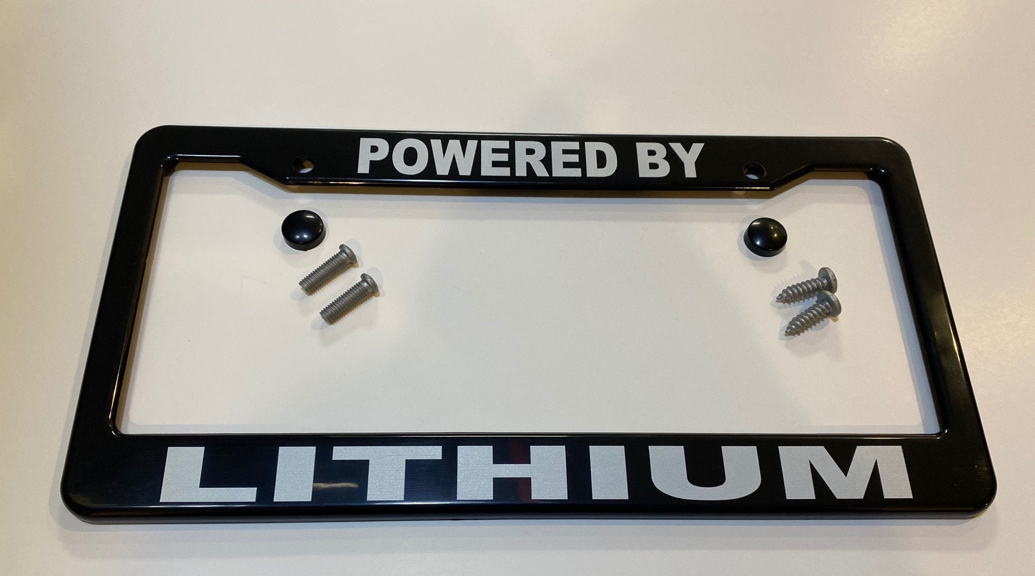 Black ABS License Plate Frame with lettering "POWERED BY LITHIUM" for